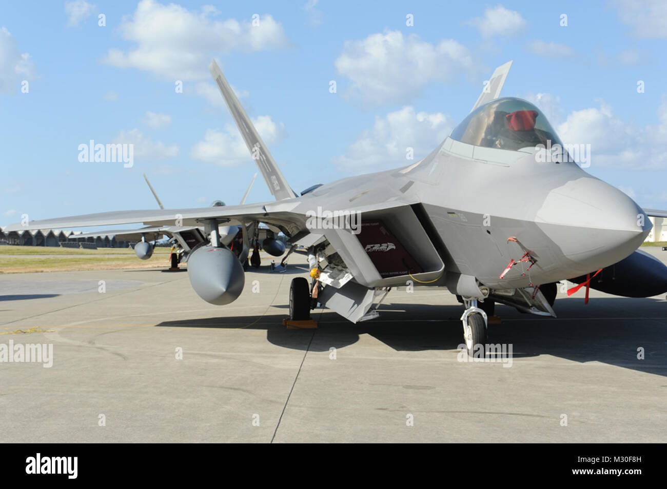 An F-22 Raptor sits on the flight line at Kadena Air Base, Japan, Oct ...