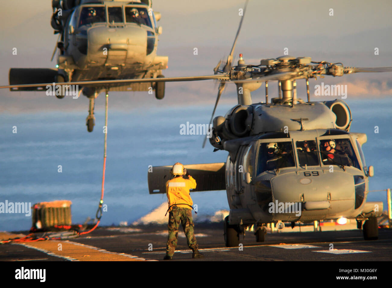 A Sailor directs an MH-60S Sea Hawk helicopter by #PACOM Stock Photo ...