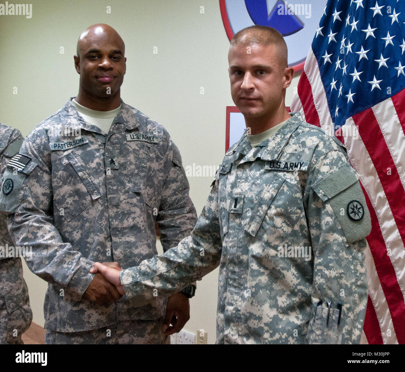 First Lt. Brian Ricco hands off his second lieutenant rank to Sgt ...