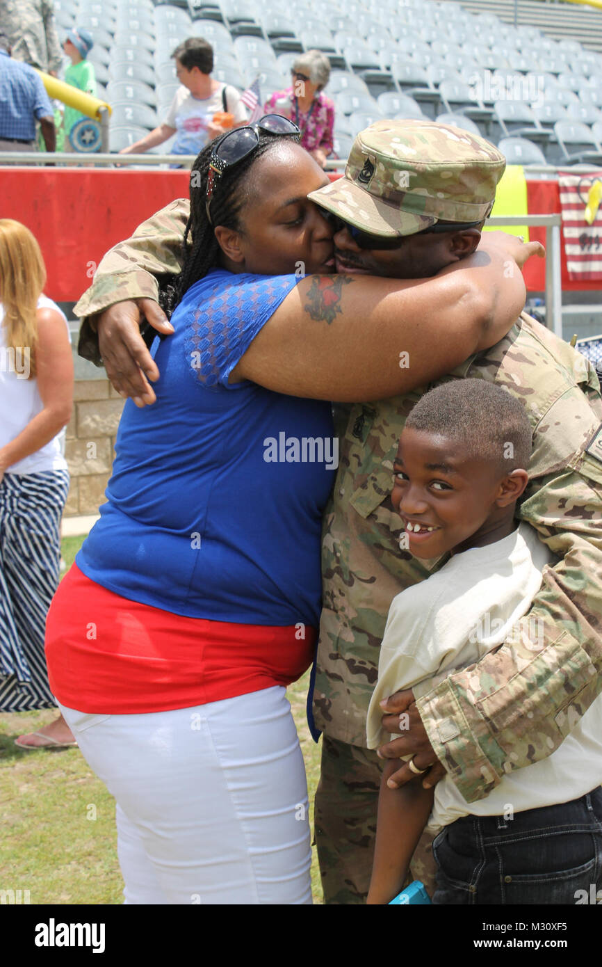 First Sgt. Eric Roberson with the 1230th Transportation Company, hugs ...