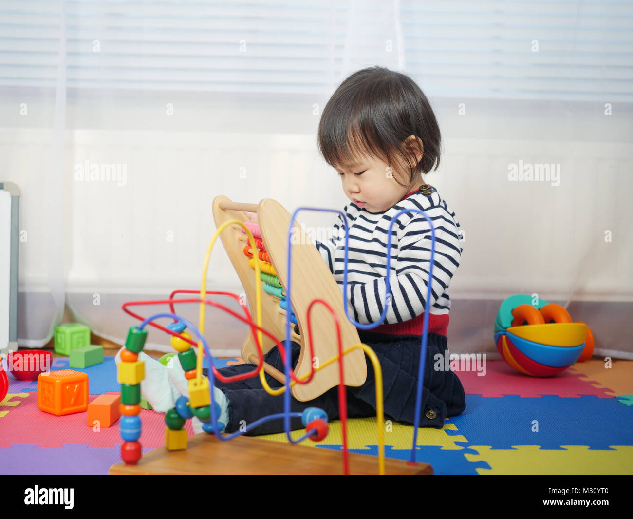 baby girl play toy at home Stock Photo - Alamy