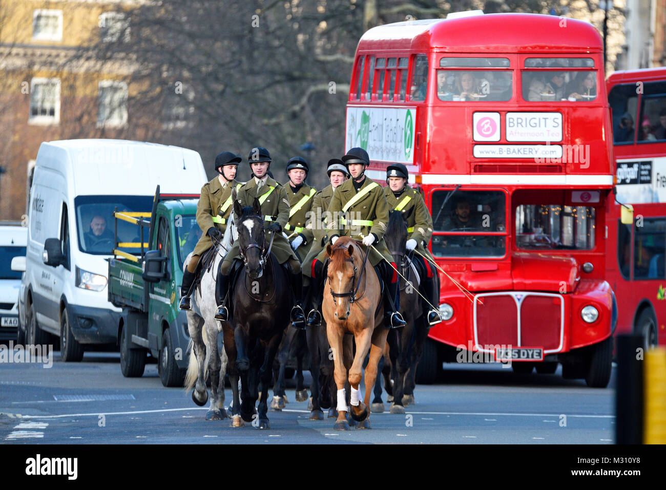 British Army mounted soldiers riding horses in London street traffic ...