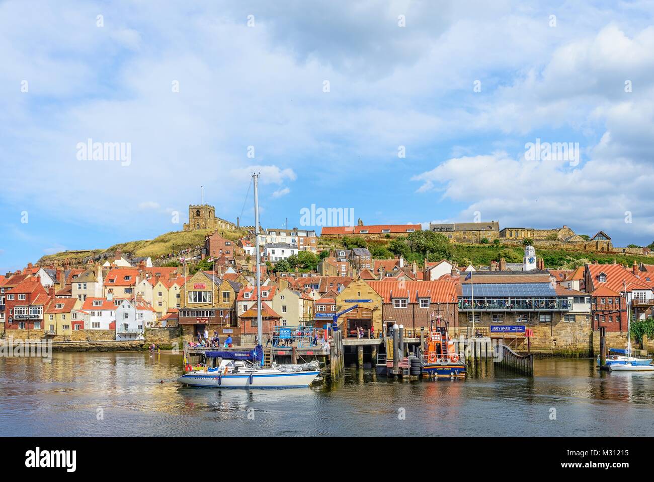 Whitby: Typical harbour view with yacht and lifeboat Stock Photo - Alamy