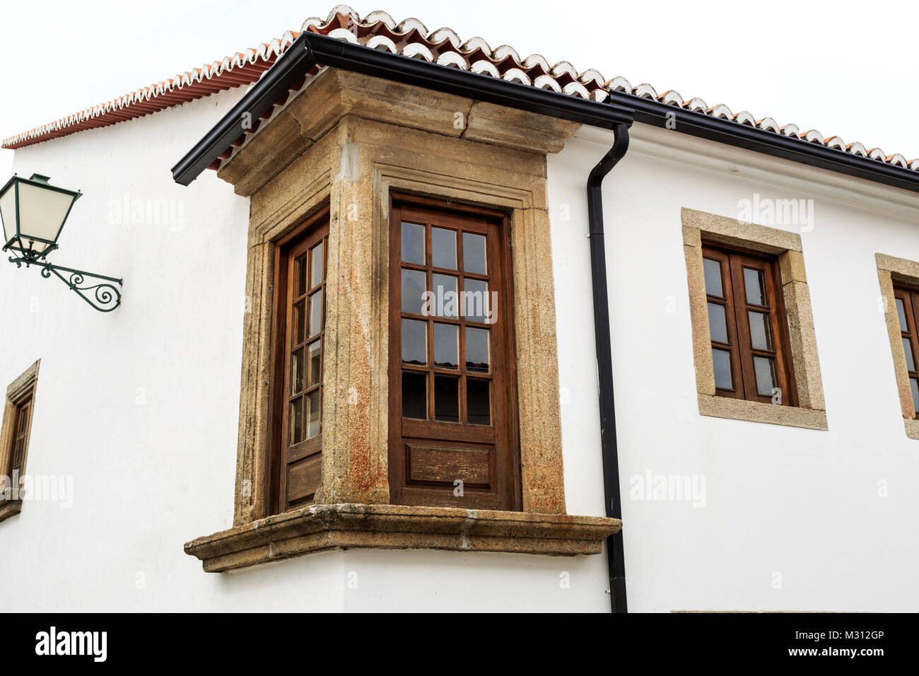 Old double window creating the corner of this old house in Miranda do ...