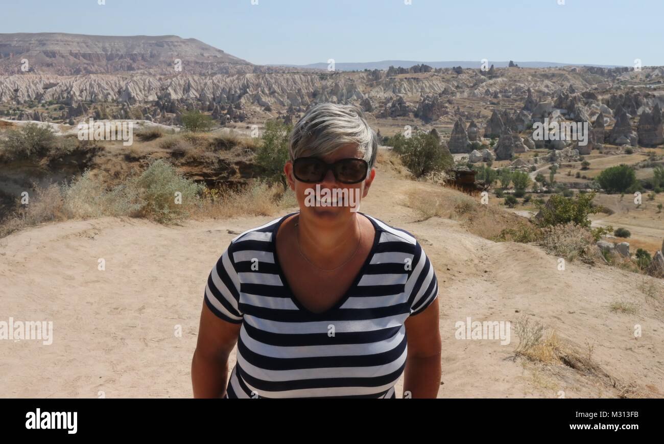 Tourists visiting some of the famous Fairy chimneys in Cappadocia which ...