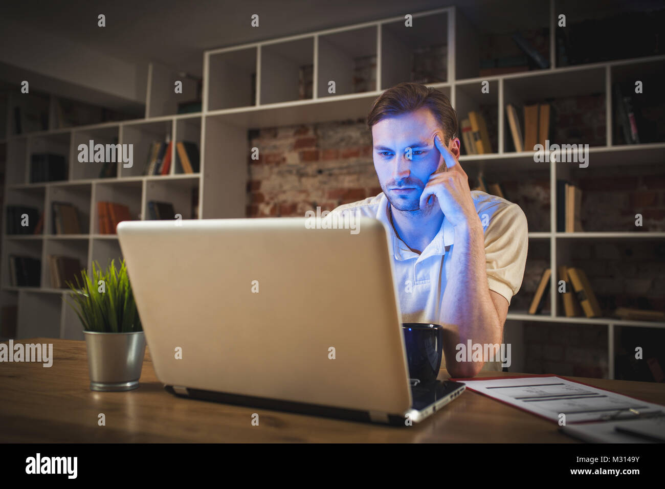 Young man with a laptop Stock Photo - Alamy