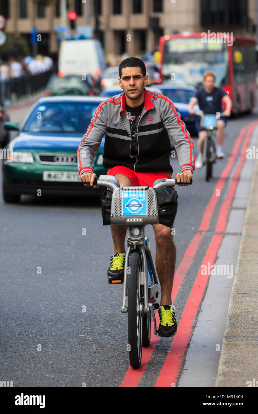 Cyclist on a Boris Bike in traffic, London England, United Kingdom ...