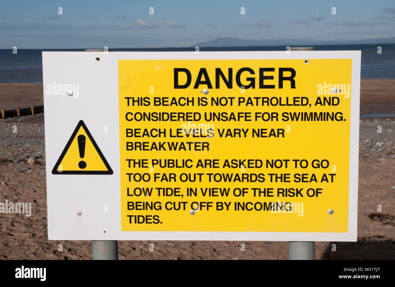 Warning sign on beach Stock Photo - Alamy