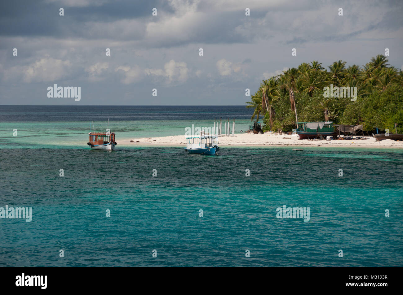 Boats Doni near small islet in the water area of the Indian Ocean ...