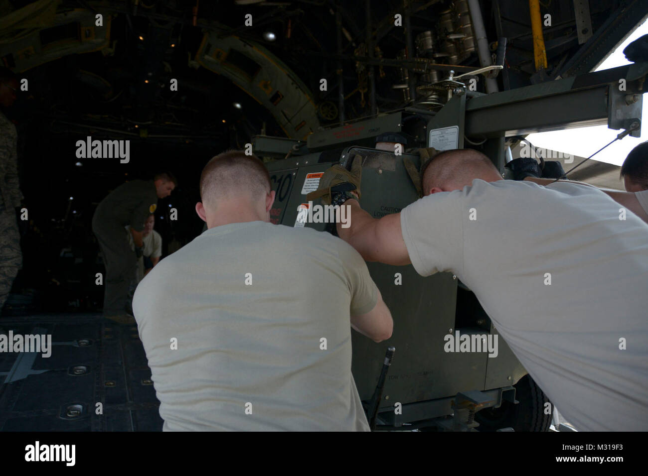 Members of the 103rd Logistics Readiness Squadron load a trailer ...