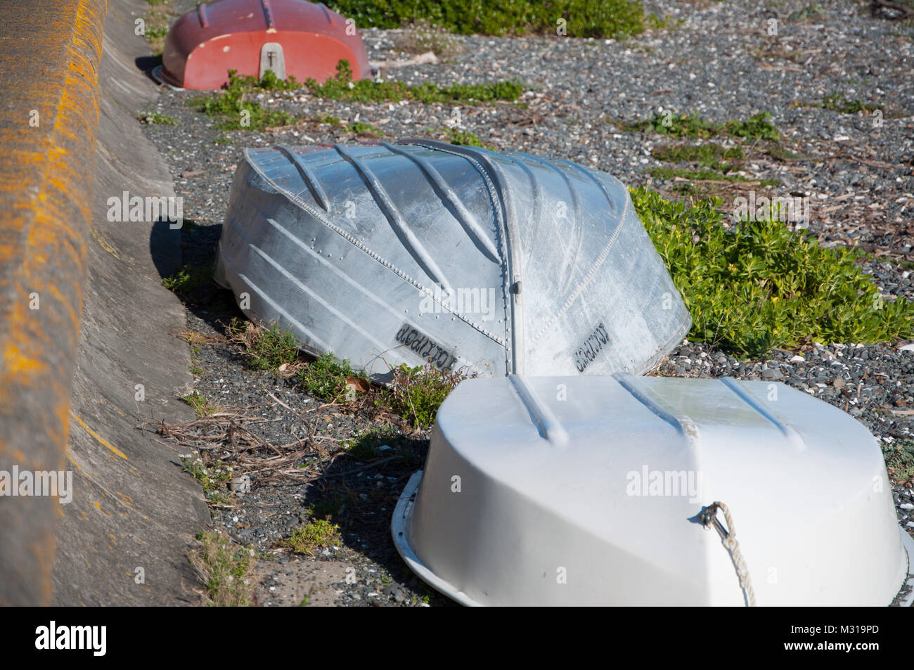 Three Row Boats On A Beach Stock Photo - Alamy