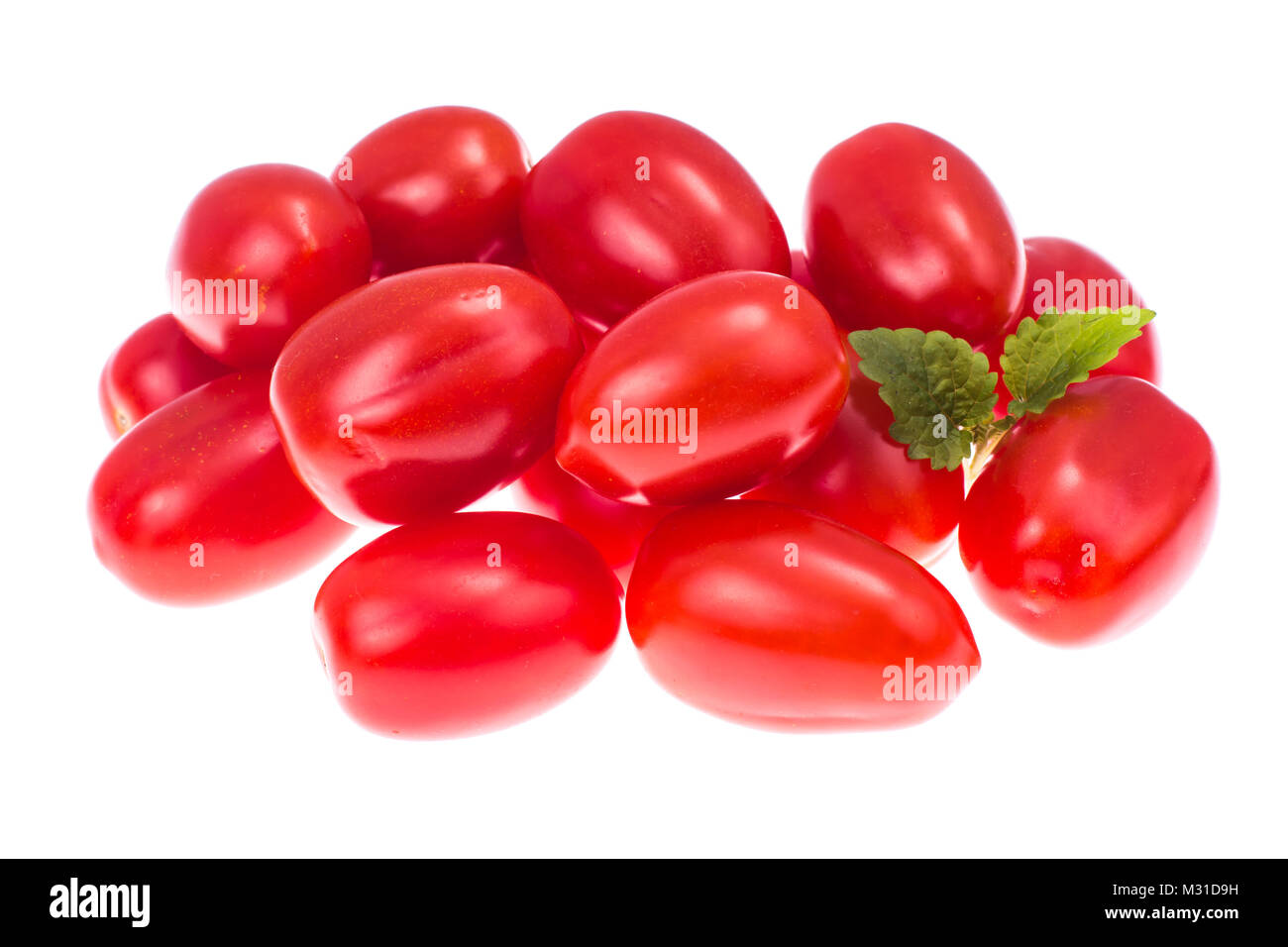 Small red tomatoes on light background Stock Photo - Alamy