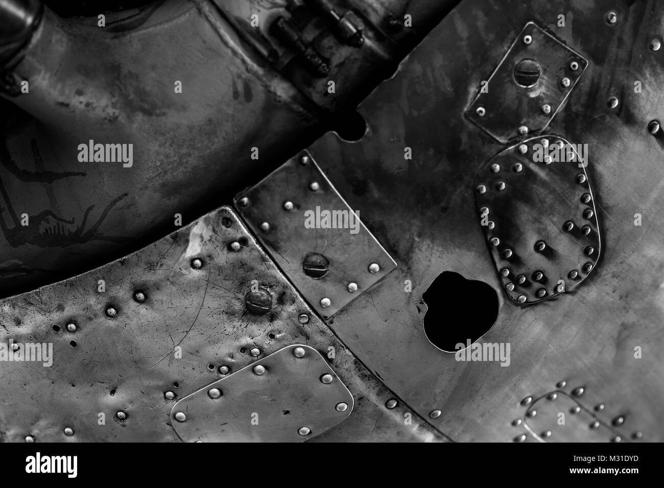 Repair patches on the engine shell of a Douglas DC-3 aircraft are seen ...