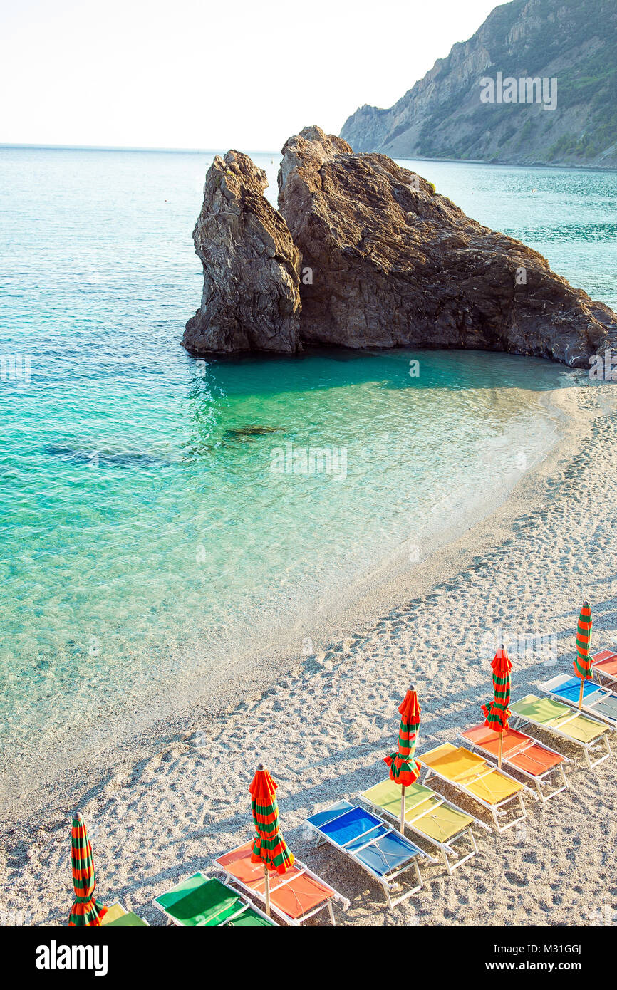 Sunbeds and umbrellas at beautiful european seashore in Monterosso in ...
