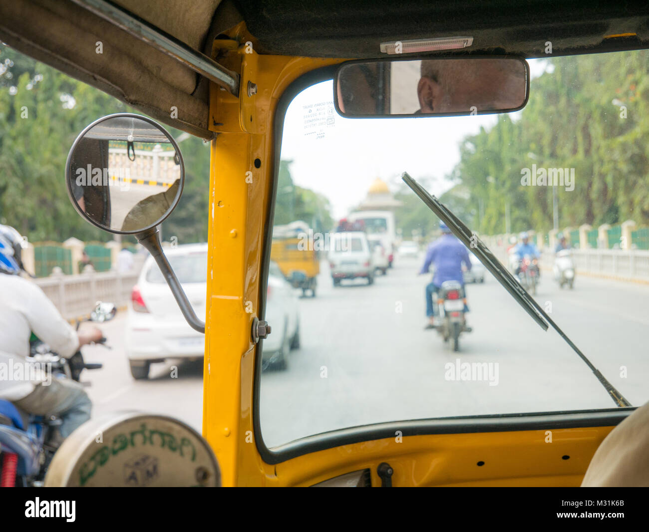 View from inside of a auto rickshaw in India. Also known as tuk tuk ...