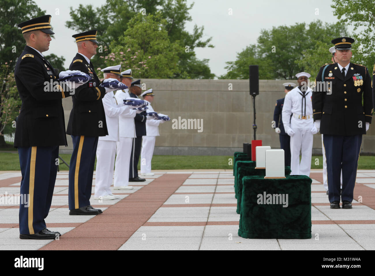 ARLINGTON, Va. – Military chaplains hold folded flags, one for each of ...