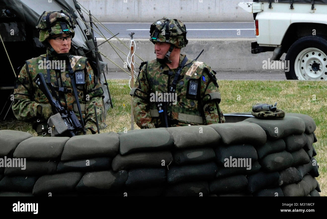 Members of the Japanese Self-Defense Force defend a bunker during the ...