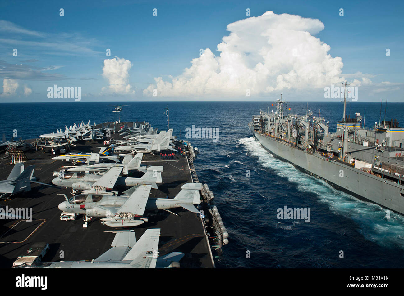 US aircraft carriers transit to conduct a replenishment at sea by # ...