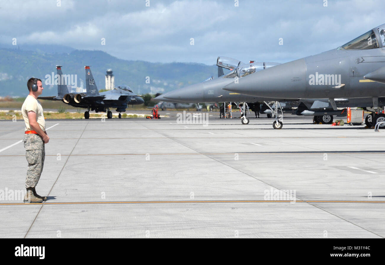 A 391st Fighter Squadron crew chief prepares to guide an F-15E Strike ...