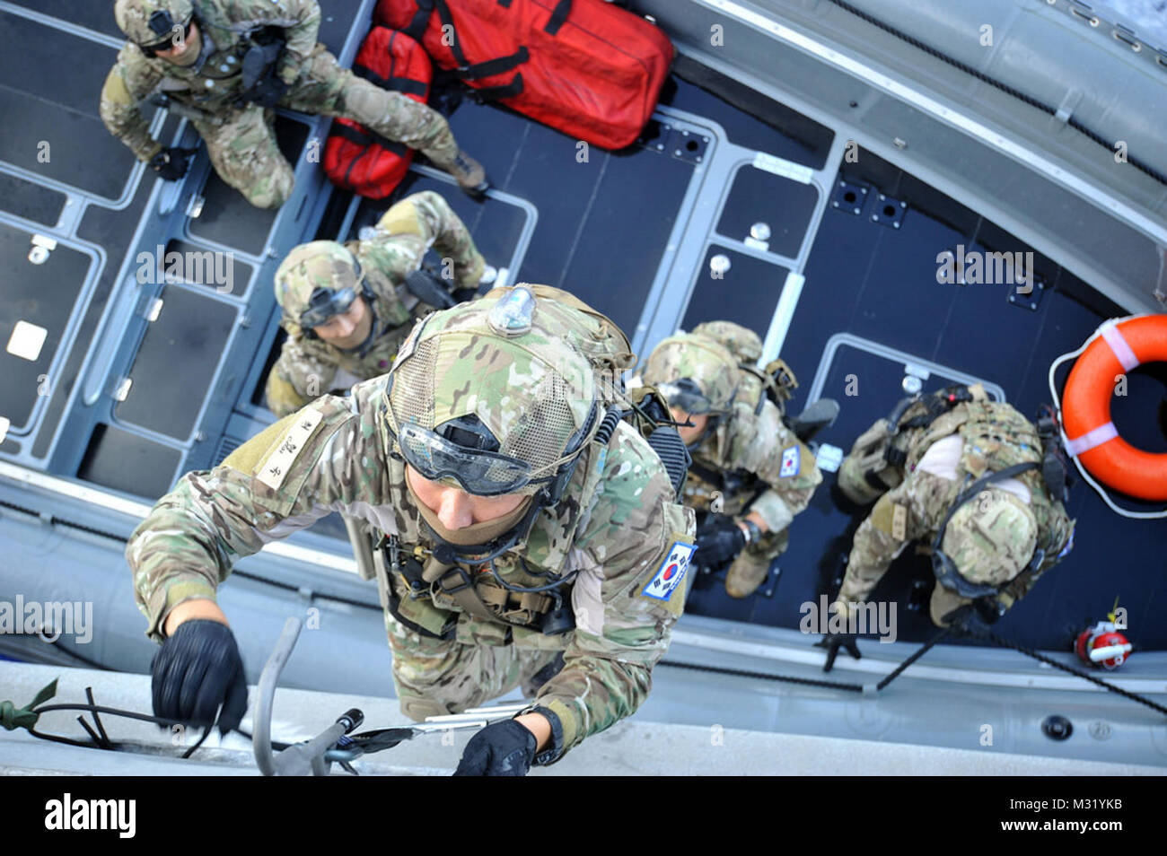 ROK special forces scale up the side of the littoral combat ship by # ...