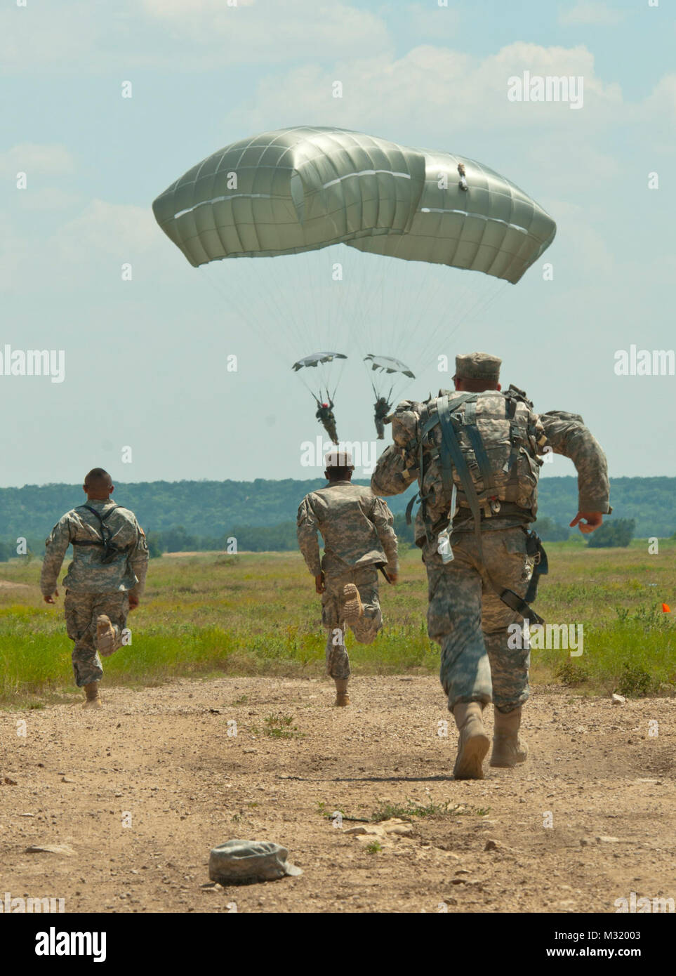 Drop zone support Soldiers sprint to two airborne jumpers who nearly ...