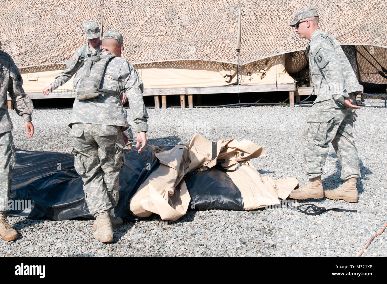 Soldiers of the 542nd Quartermaster Company unroll an air-supported ...