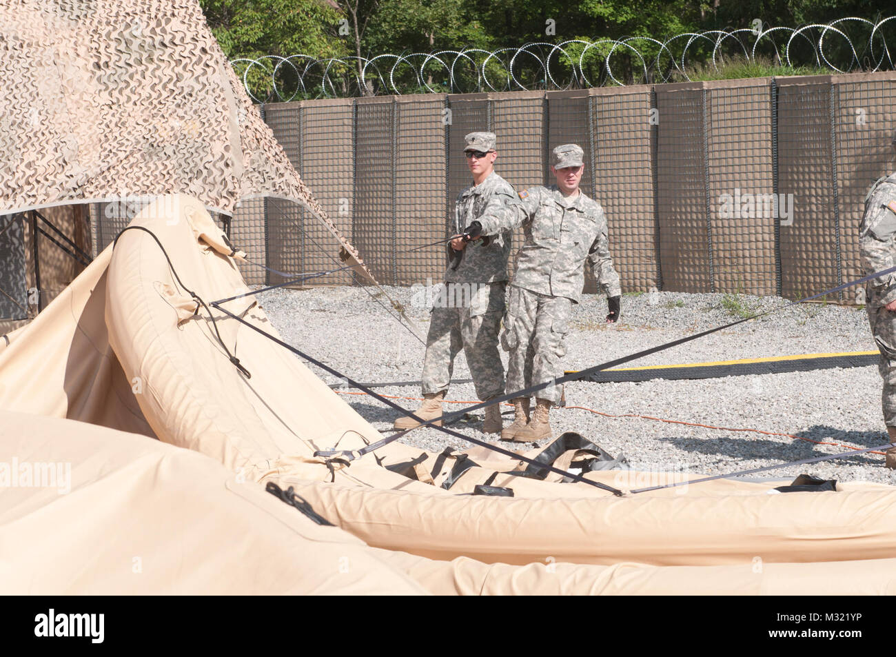 Soldiers of the 542nd Quartermaster Company set up an air-supported ...