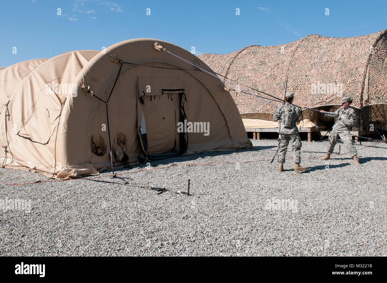 Soldiers of the 542nd Quartermaster Company set up an air-supported ...