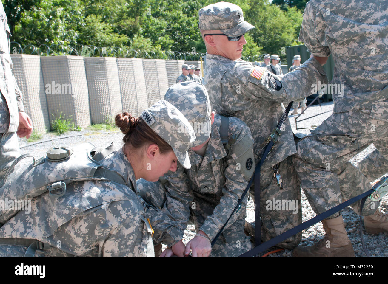Soldiers of the 542nd Quartermaster Company, tighten straps to secure ...