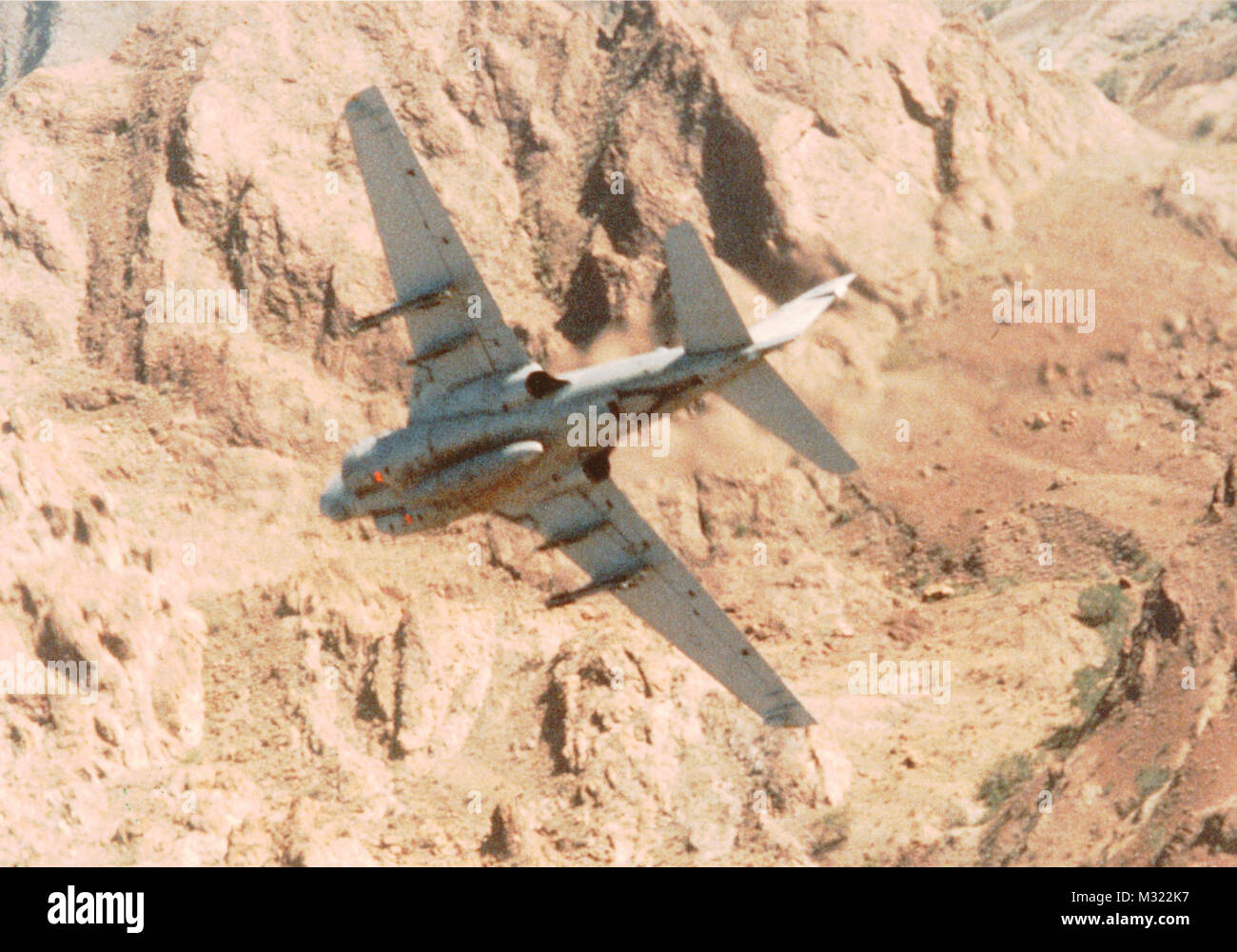 An A6-E rolls into the grove in a canyon on the mountian range at ...