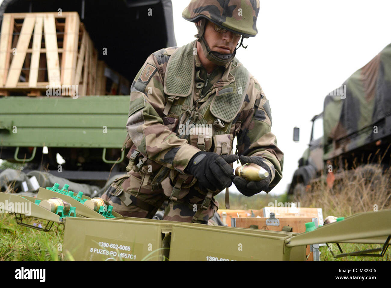 A French Army soldier unpacks point detonating fuses during a life fire ...