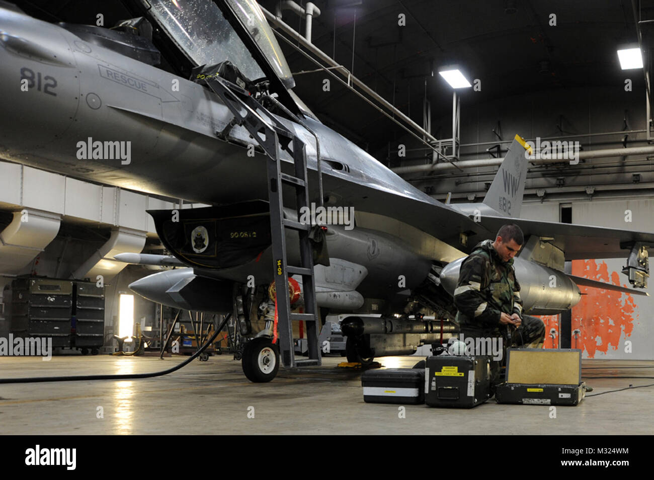 Prepares to switch out a wing fuel tank on an F-16 Fighting Falcon by # ...