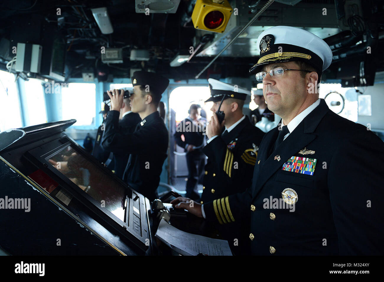 Capt. Tom Disy watches over the bridge team as the ship enters port in ...