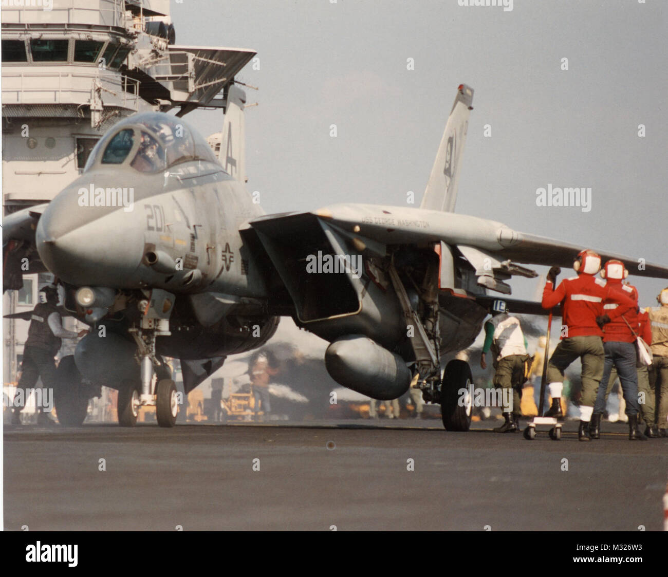 an f-14 waits for the launch signal on the catapult of the uss george ...