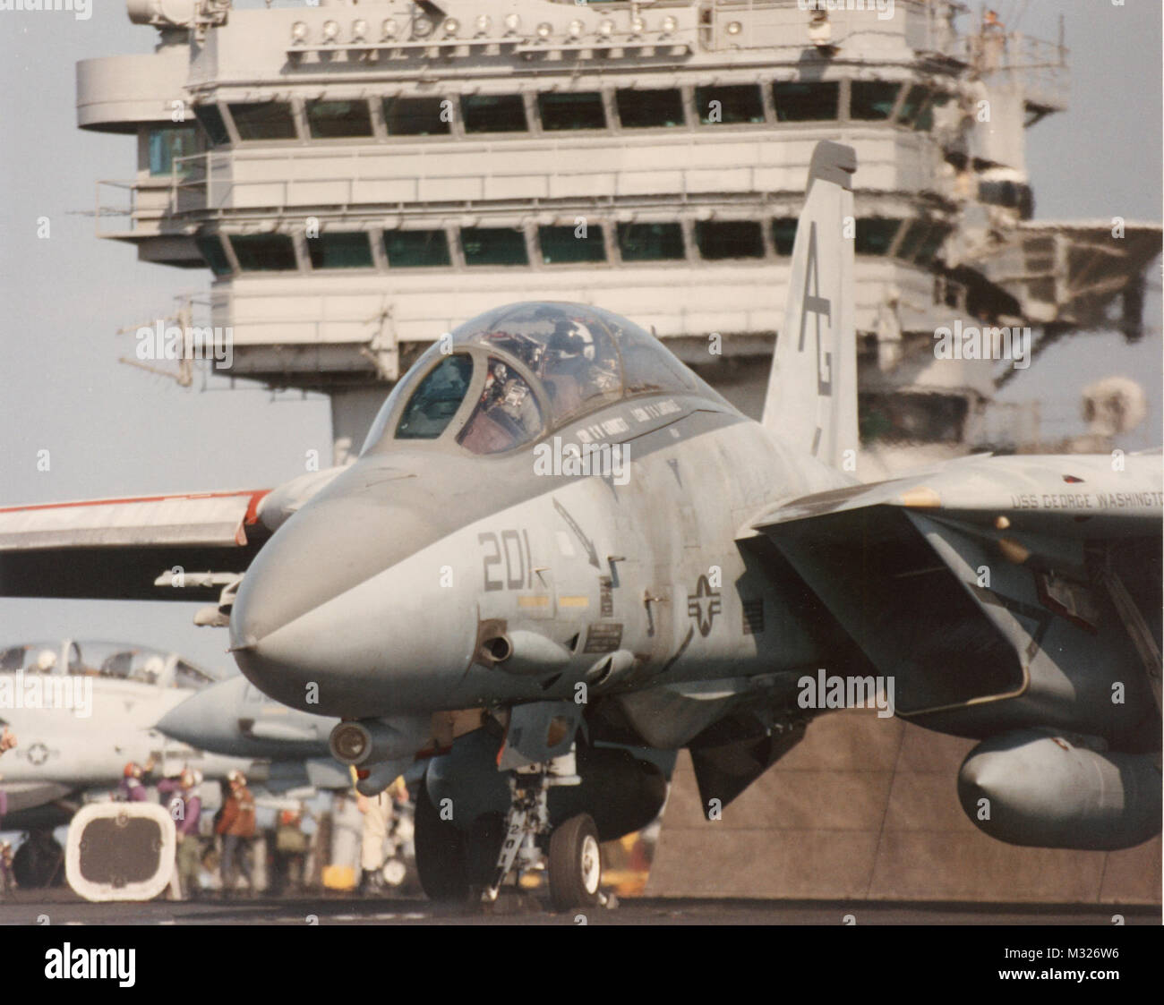 an f-14 waits for the launch signal on the catapult of the uss george ...