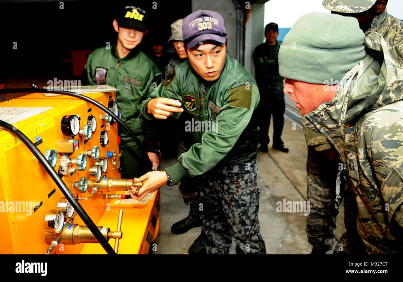 A member of the Japanese Air Self Defense Force explains how to use a ...