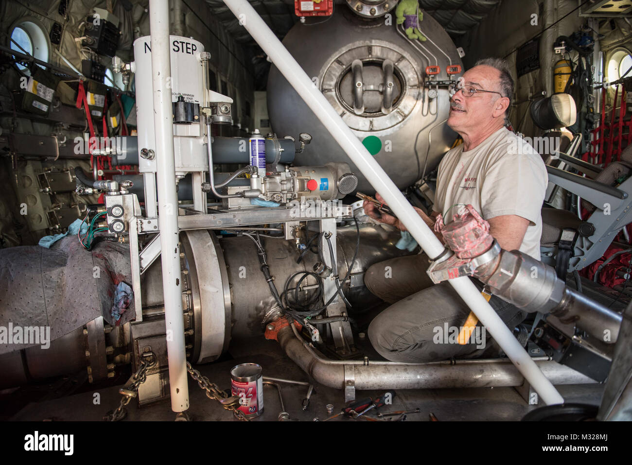 A technicians perform repairs on a Modular Airborne Fire Fighting ...