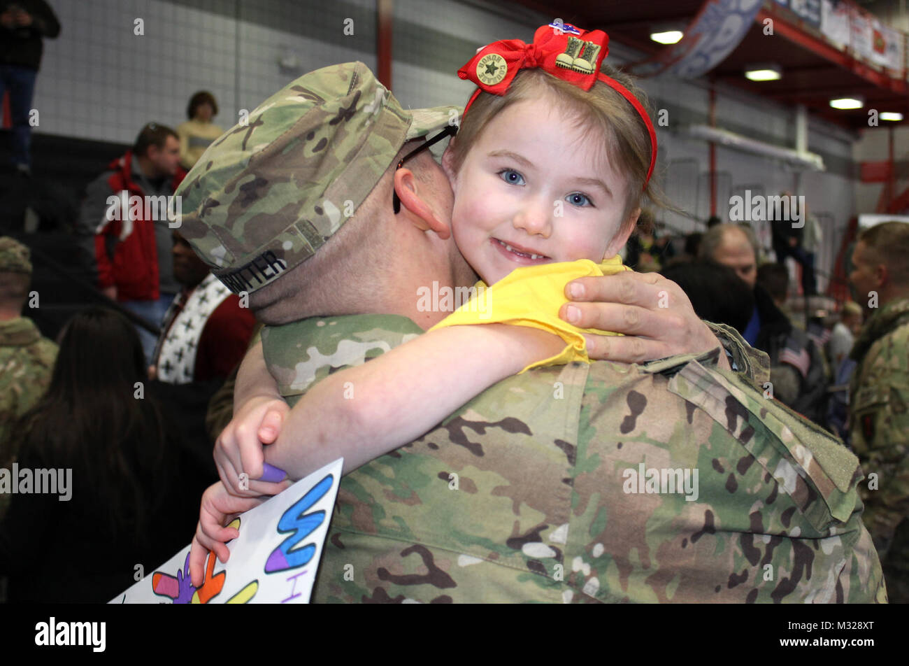 Pfc. Timothy Trotter, embraces his daughter Talitha, 5, during a ...