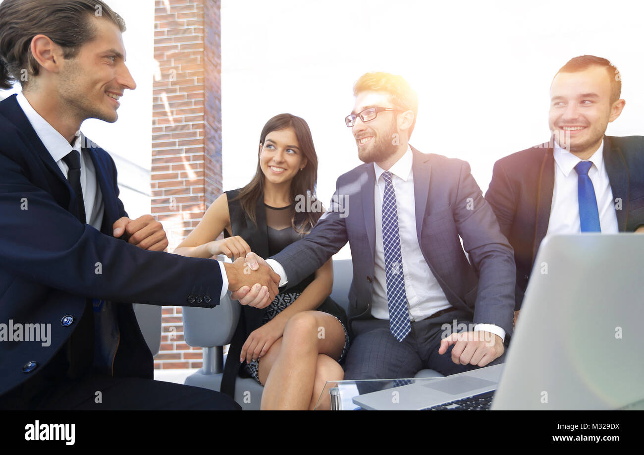 handshake Manager and the client at a meeting in the office lobby Stock ...