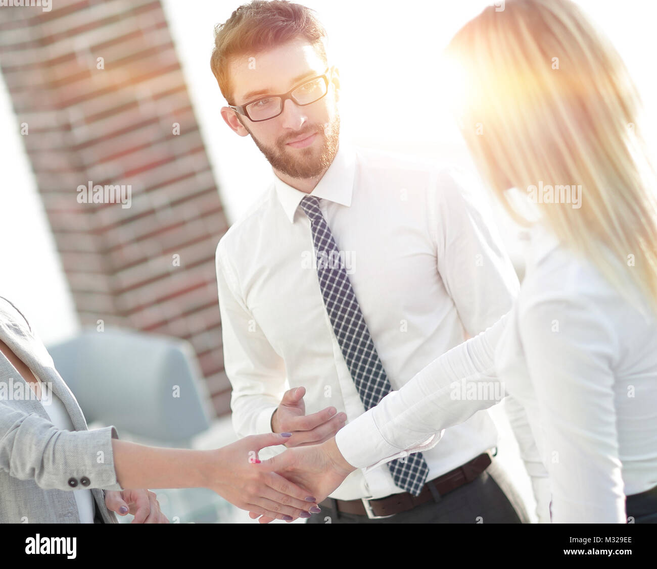 senior assistant looks at the handshake business partners Stock Photo ...