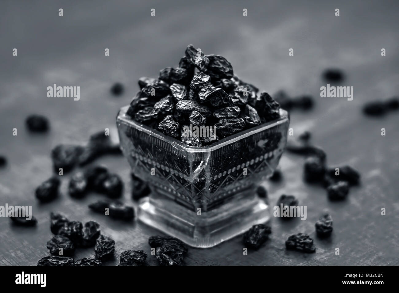 Close up of Black Raisin,Zante currant in a blue colored bowl Stock ...