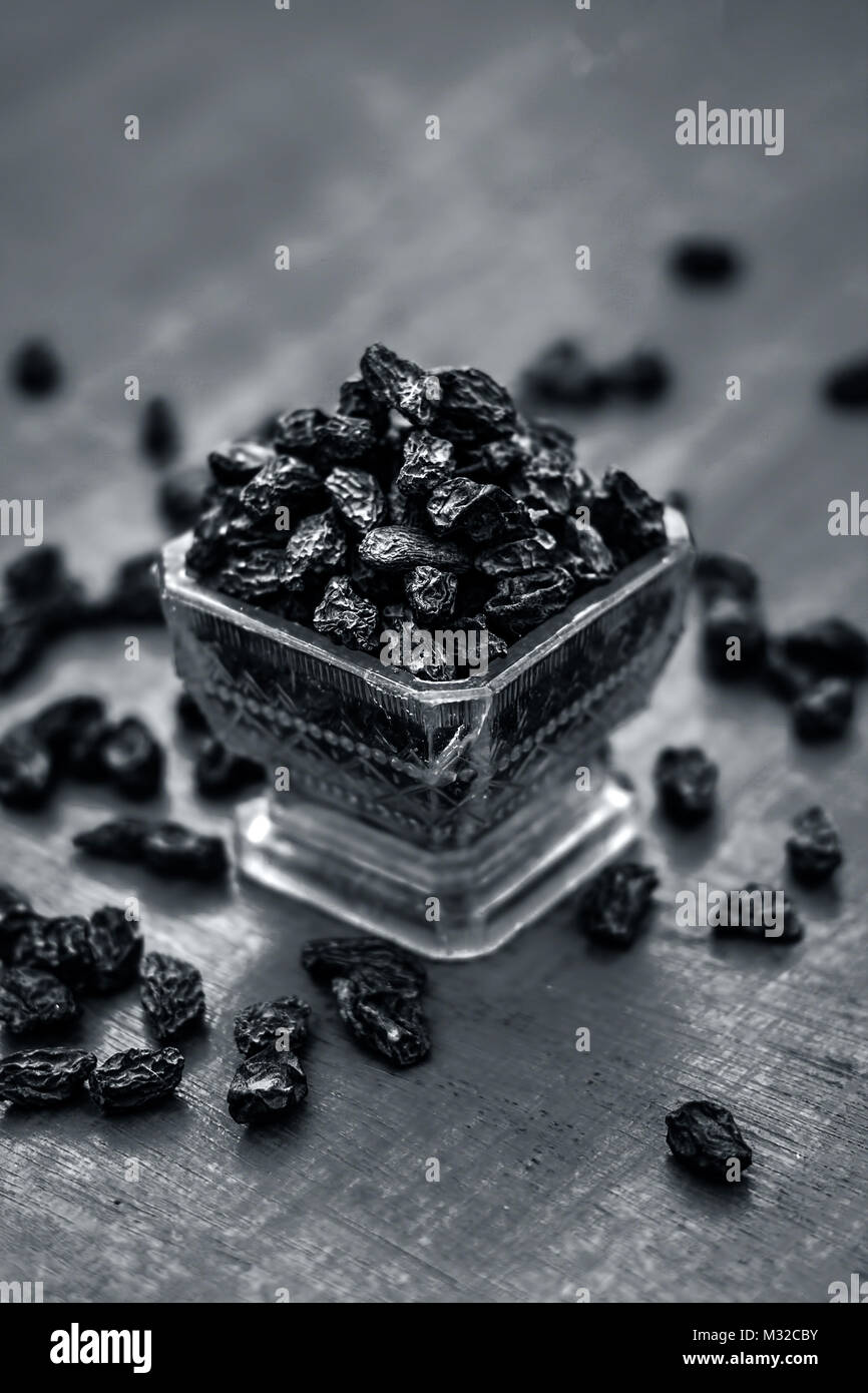 Close up of Black Raisin,Zante currant in a blue colored bowl Stock ...