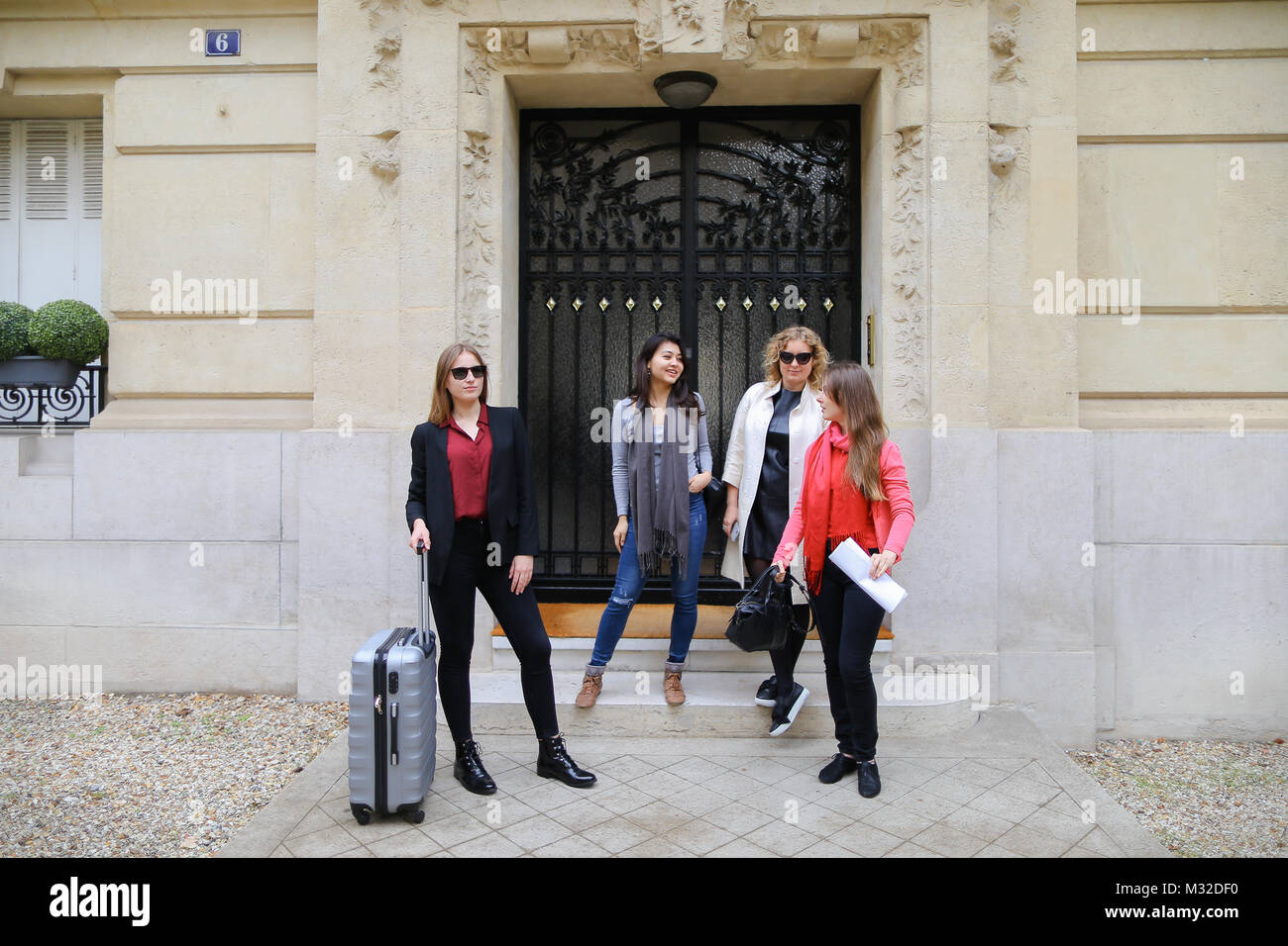 Happy students leaving university building in Stock Photo - Alamy