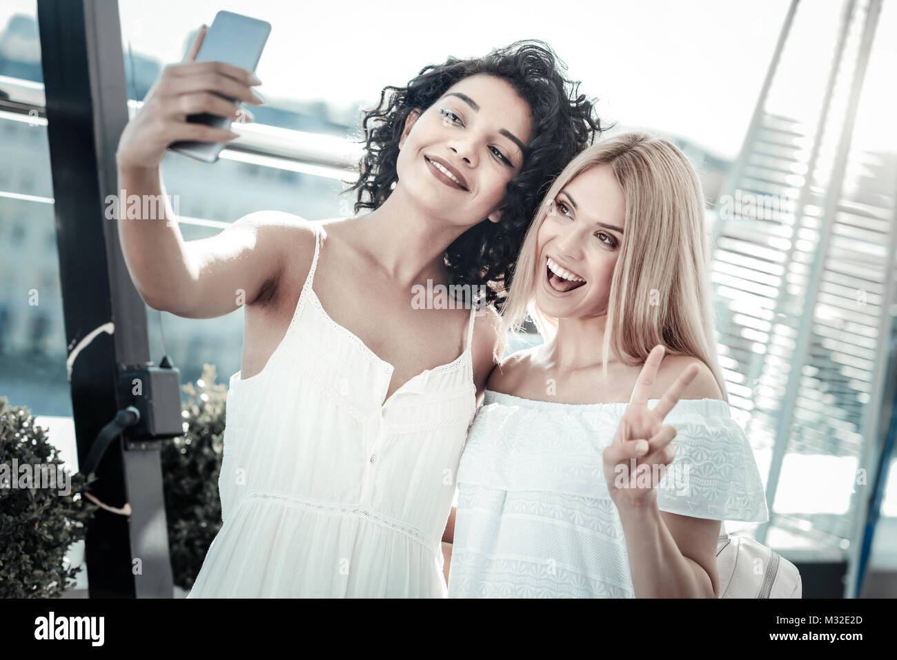 Happy cheerful women taking a selfie Stock Photo - Alamy