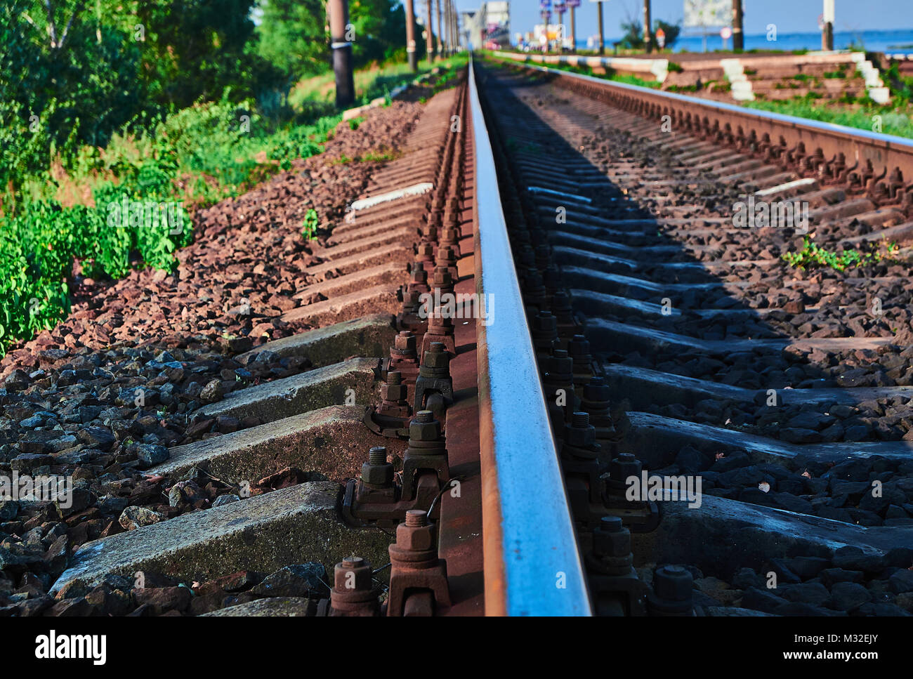 Old railway road. Train rails vivid landscape Stock Photo - Alamy