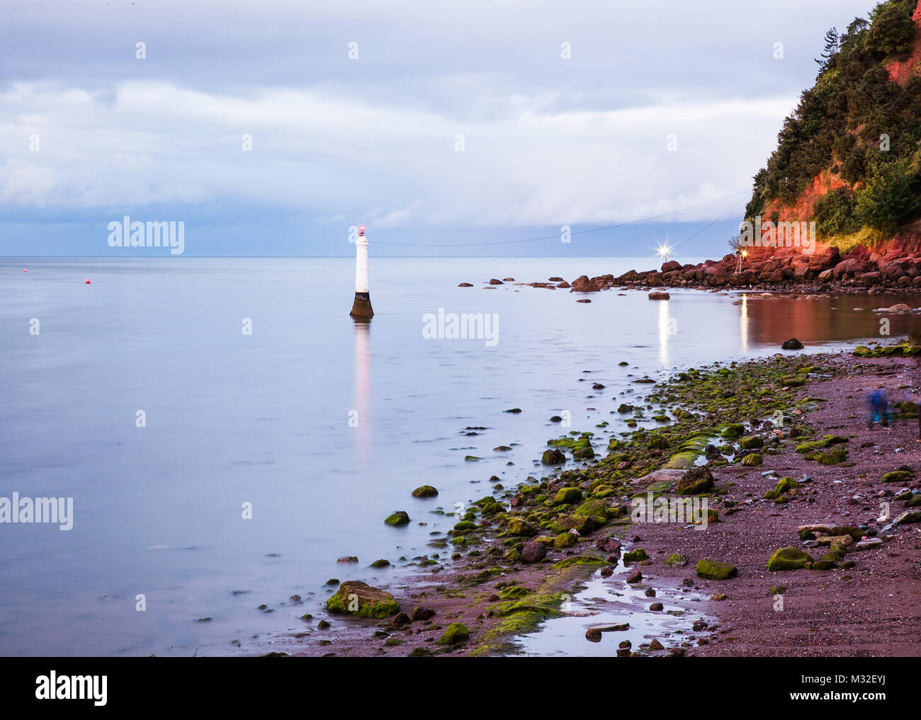 The distinctive redish colour of Shaldon beach on the Teign estuary at ...