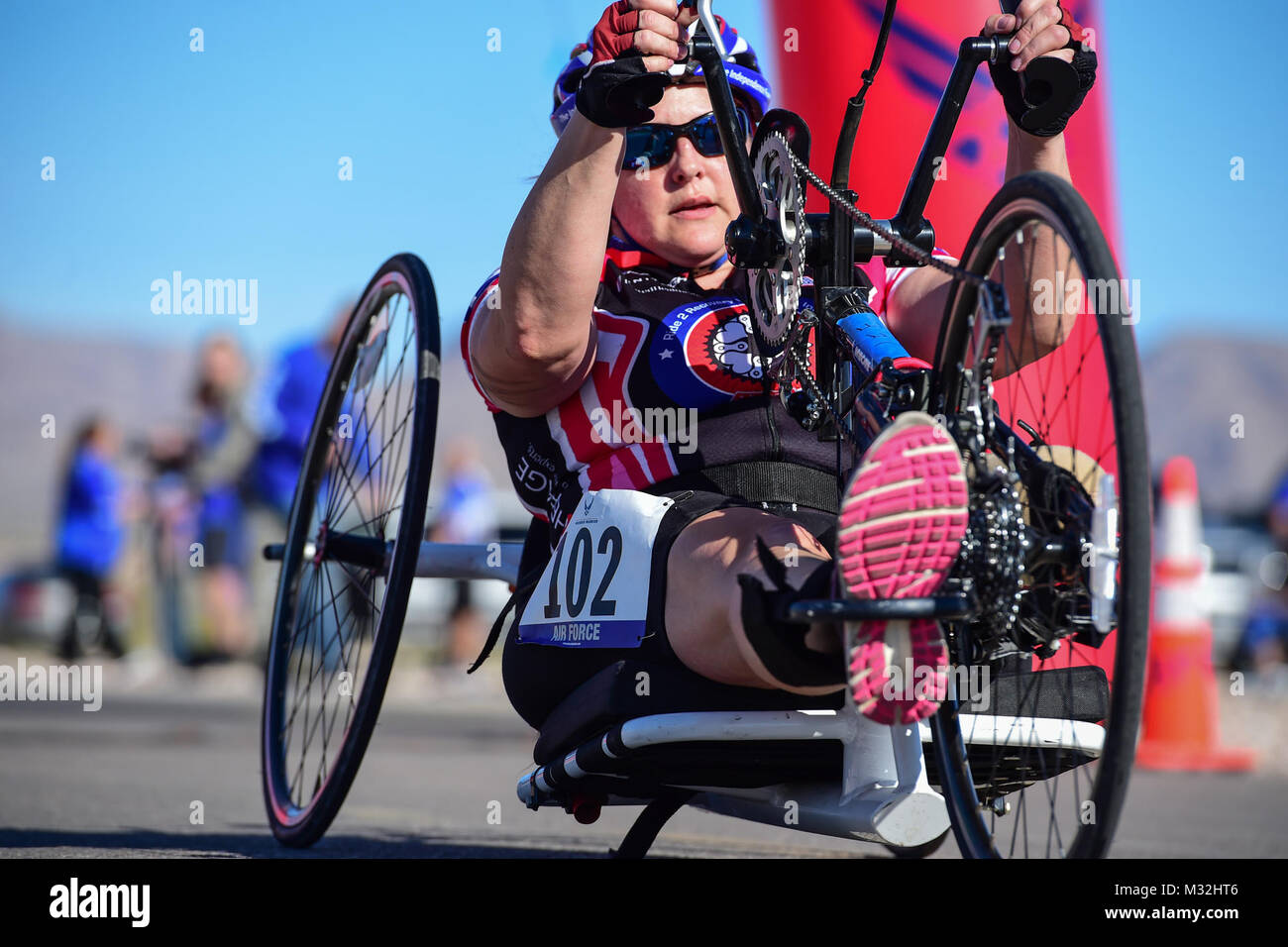 An Air Force Trials cycling competitor rides toward the finish line ...