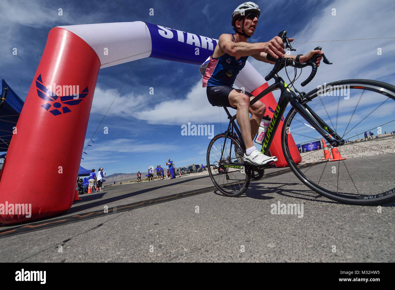 An Air Force Trials cycling competitor rides toward the finish line ...