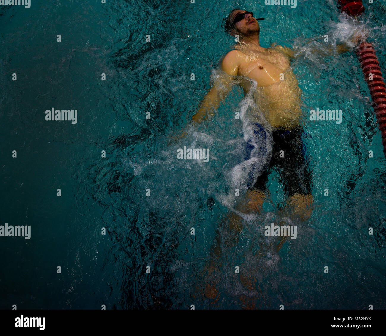 A member of Team USA completes his turn during the 50 meter backstroke ...