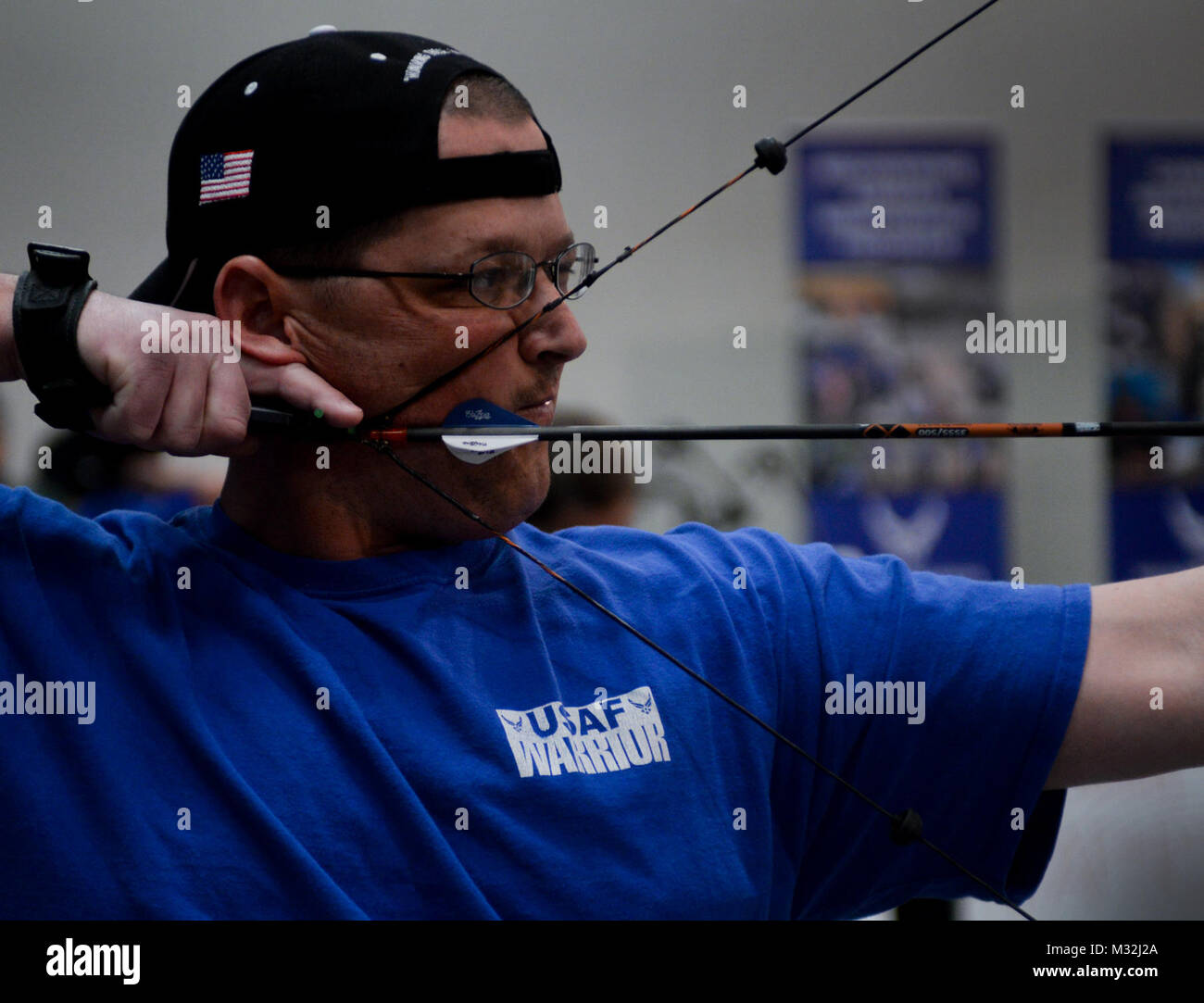 A member of Team USA lines up his shot before firing during the archery ...